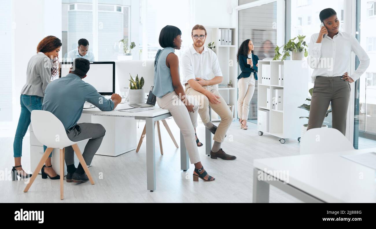 Its a busy day in the office. a group of businesspeople working in a ...