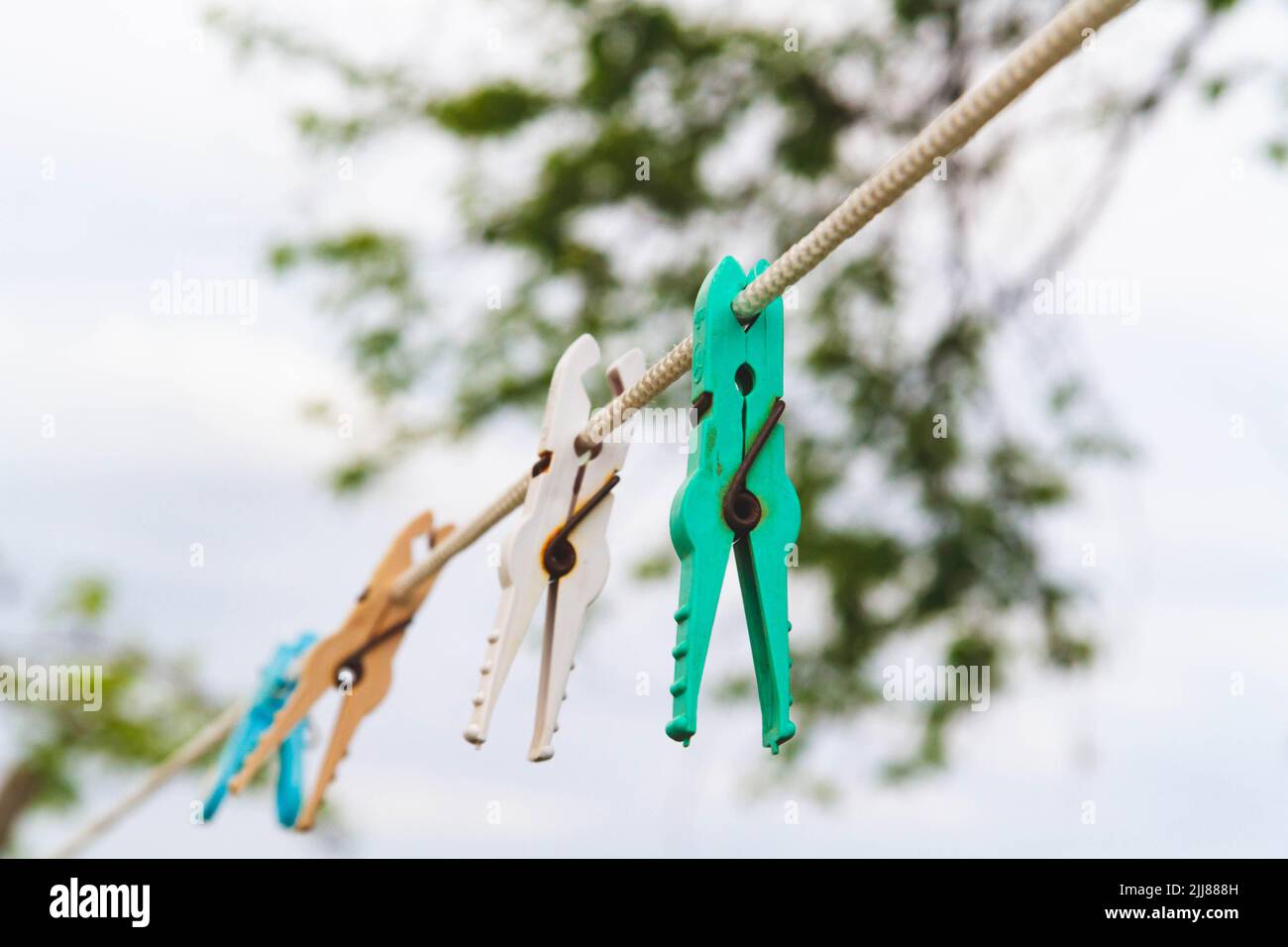 Clothespins for drying clothes on a rope. Clothesline . Laundry washing ...