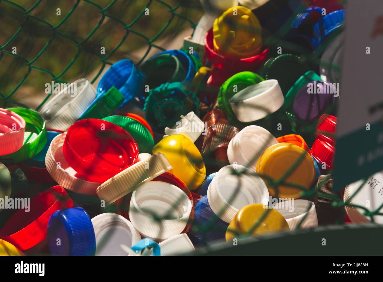 The problem of plastic waste. Lots of plastic bottle caps. The concept ...