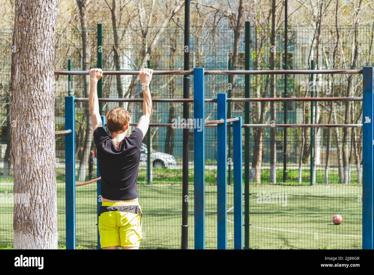 Sports. A man is engaged in a horizontal bar. Outdoor pull-ups. Sports ...
