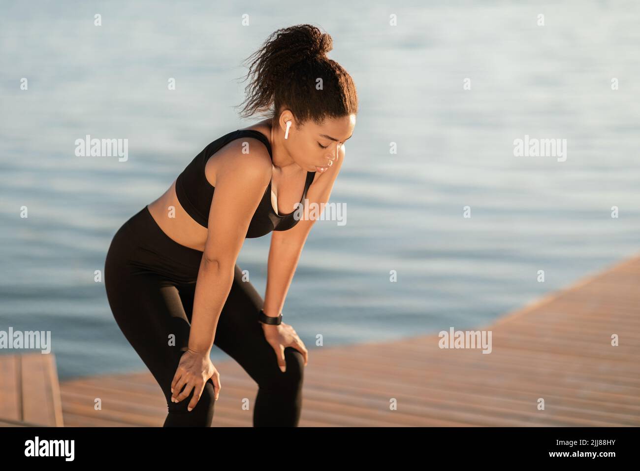 Tired female athlete stretching hi-res stock photography and images - Alamy