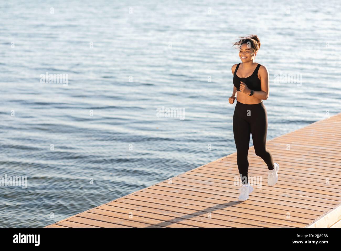 Black woman running hi-res stock photography and images - Alamy