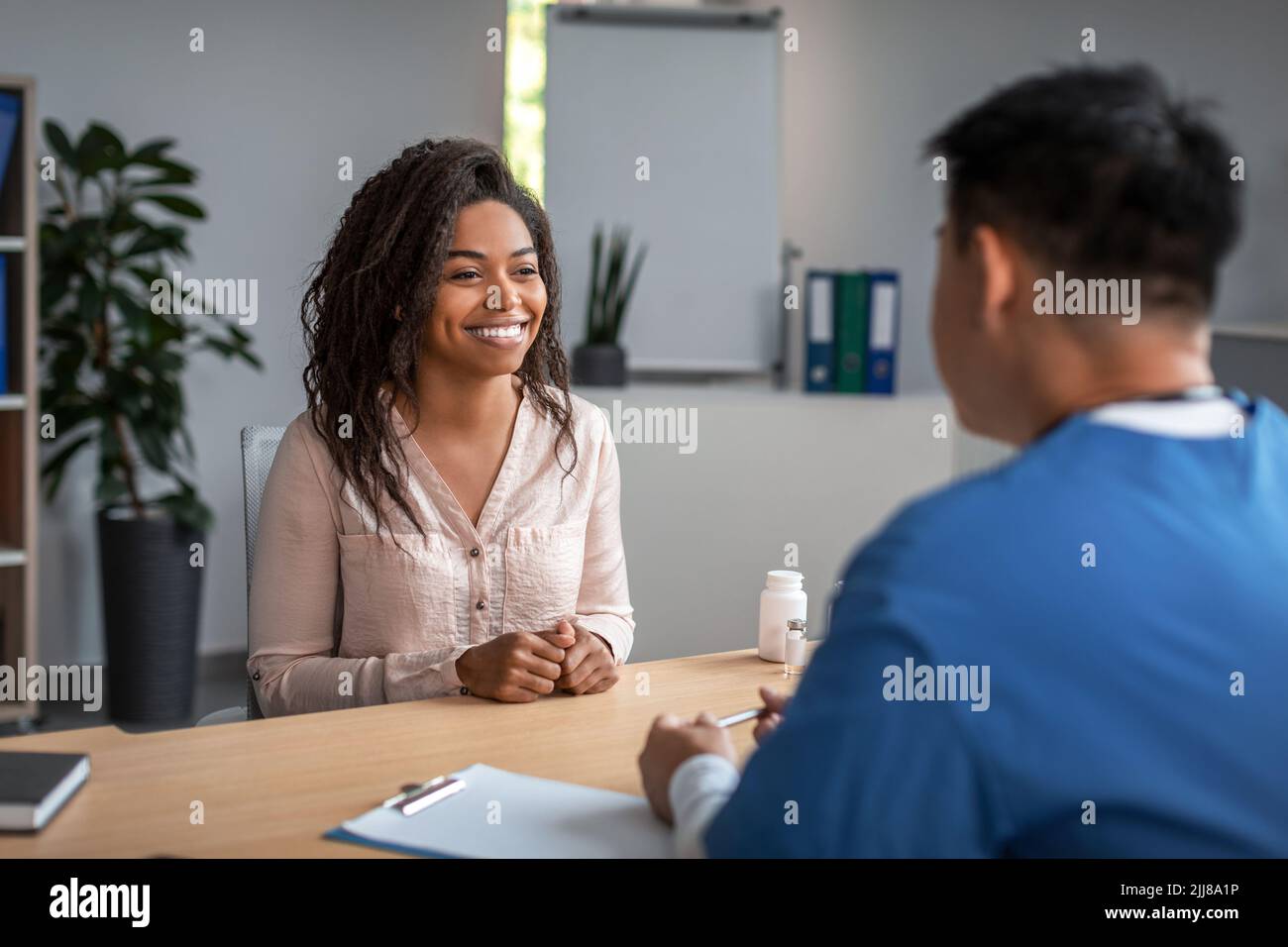Happy pretty young african american woman patient in consultation with ...