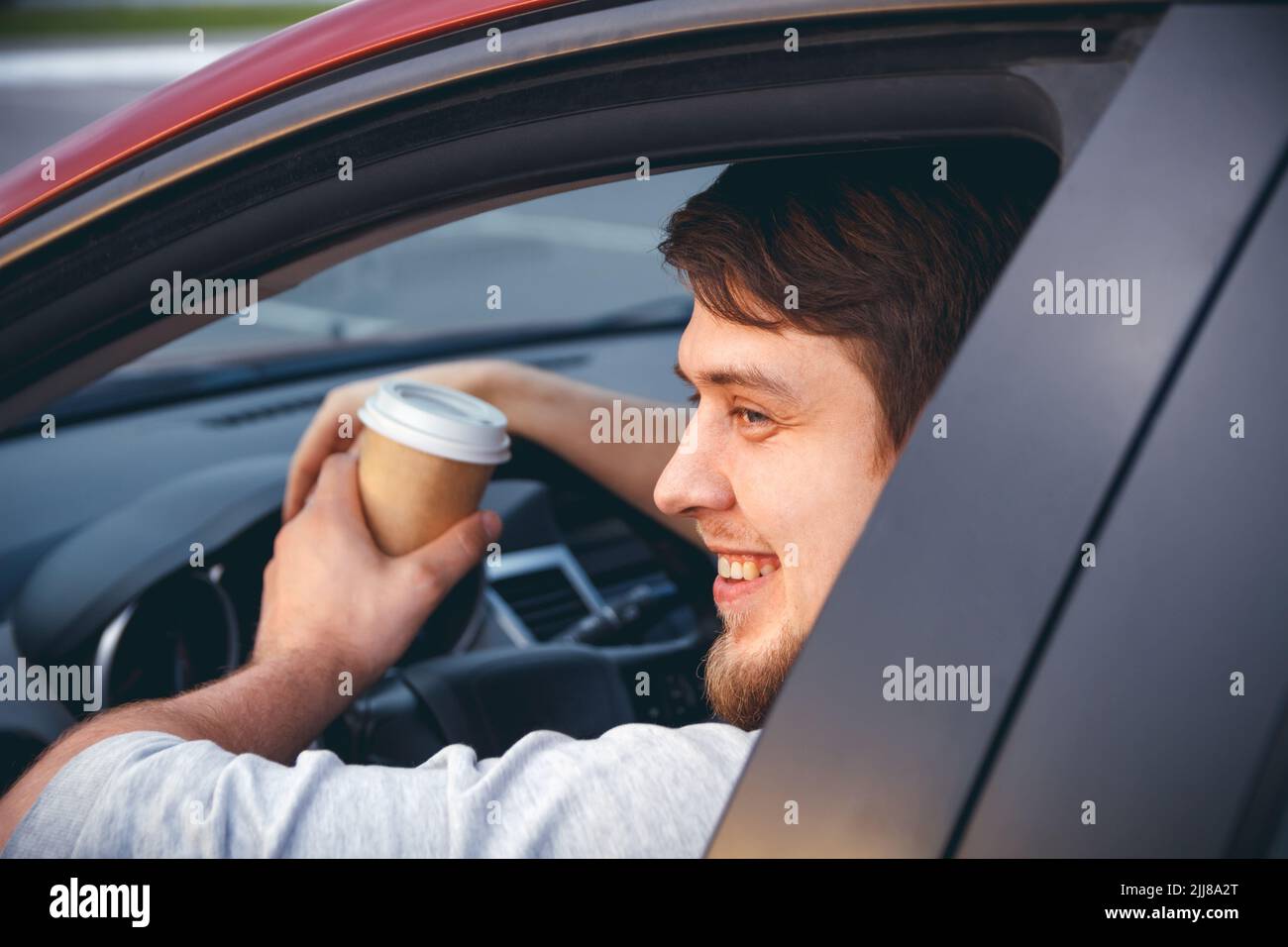Man drinking coffee driving car hi-res stock photography and images - Alamy