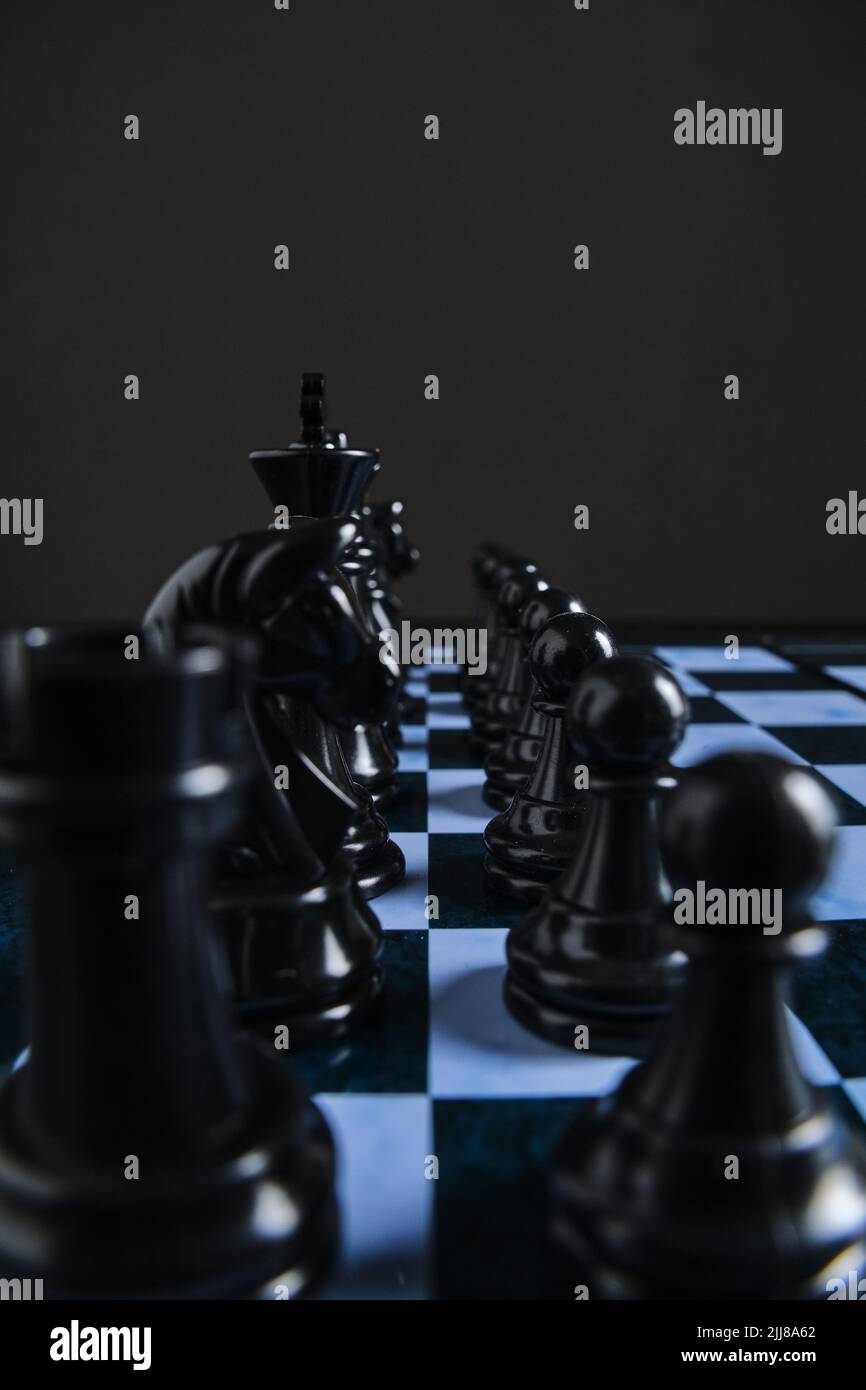 Black chess pieces on a chessboard Stock Photo - Alamy