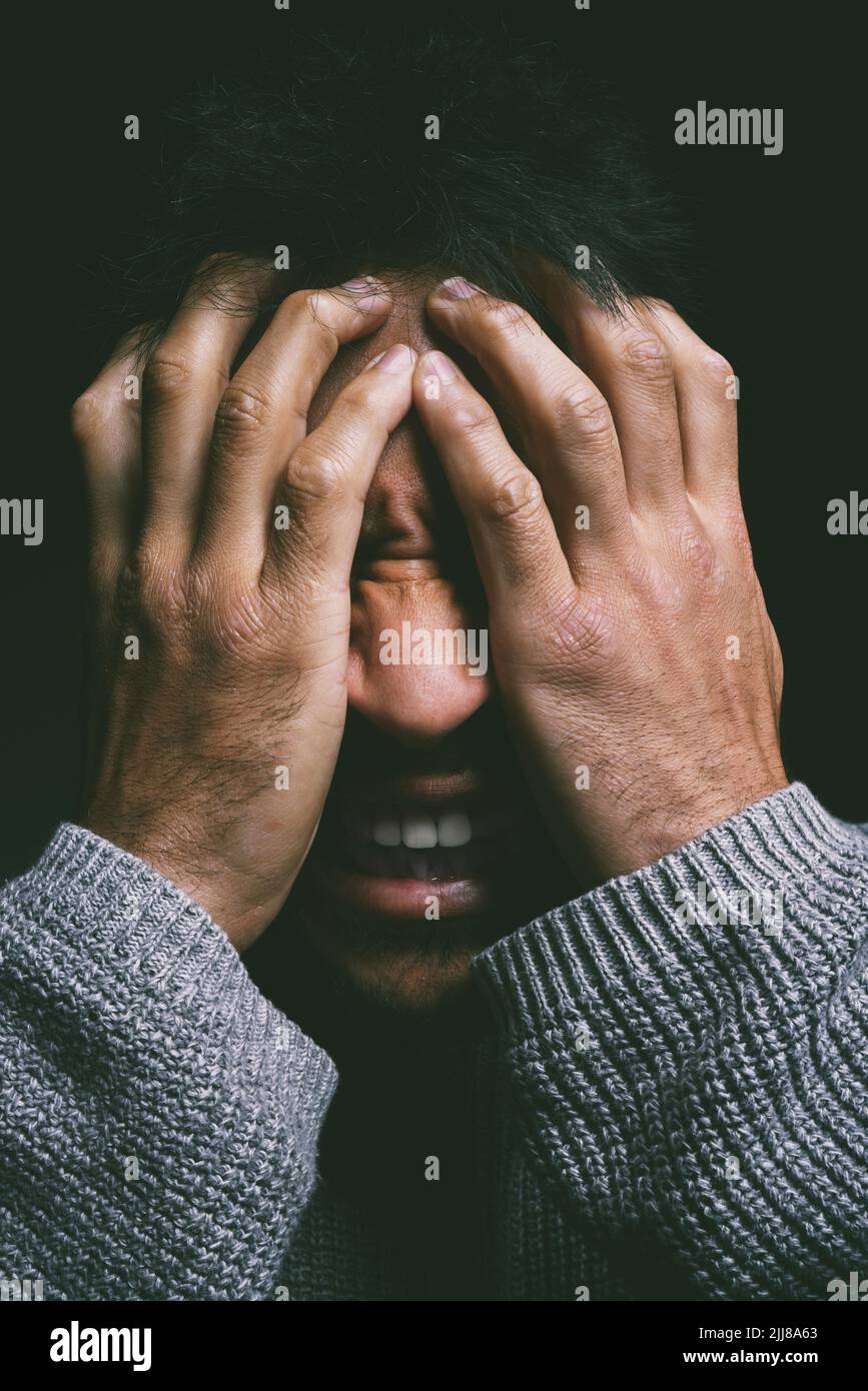 Someone make it stop. Studio shot of a young man experiencing mental ...