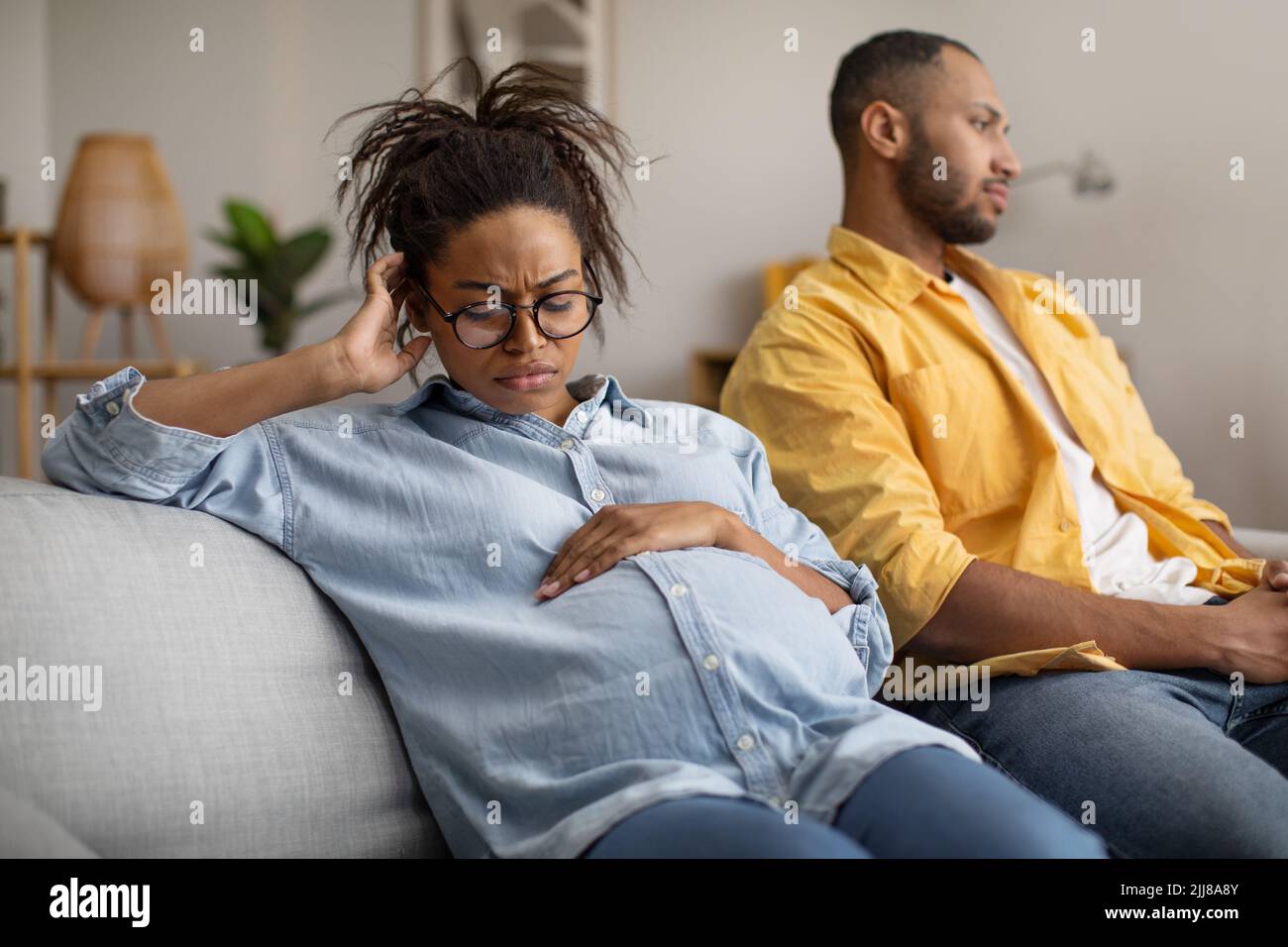 Unhappy Pregnant Black Wife Sitting Near Indifferent Husband At Home ...
