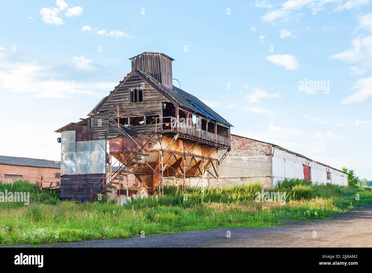 Old abandoned agricultural building with rusty iron walls. Soviet and ...