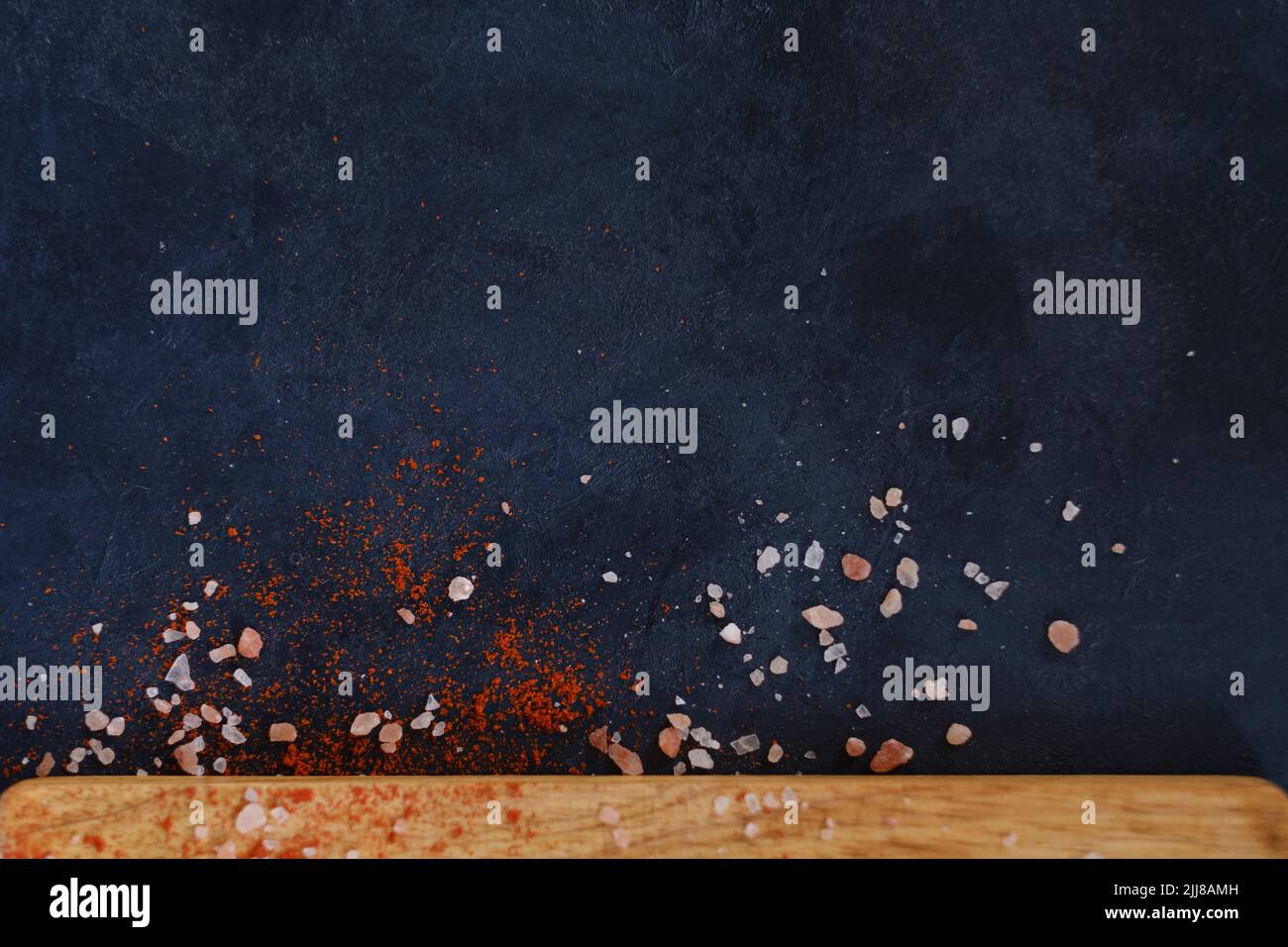 dark background chunks salt red paprika condiment Stock Photo - Alamy