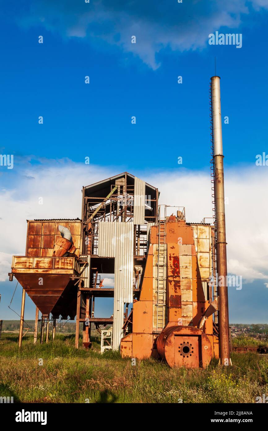 Old abandoned agricultural building with rusty iron walls. Soviet and ...