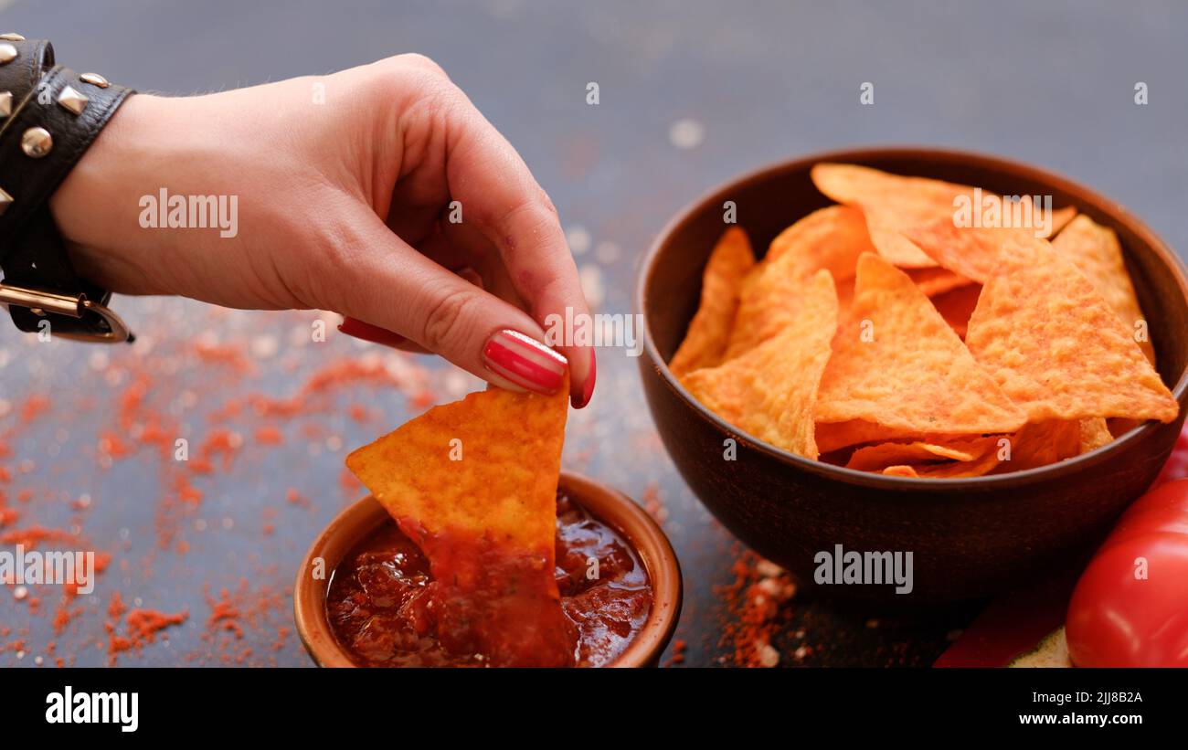 tortilla nacho chip food snack hand dip sauce Stock Photo - Alamy