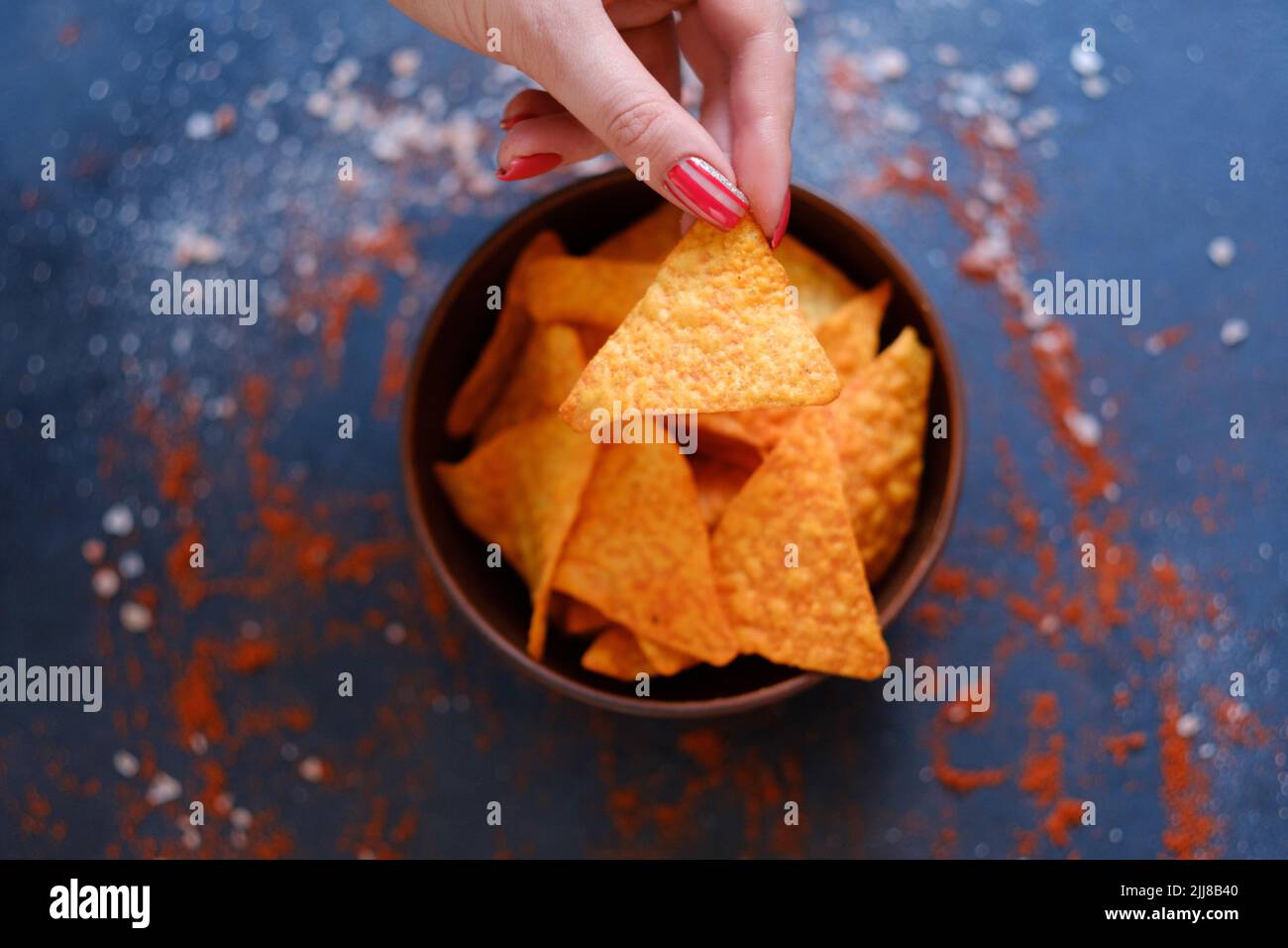 tortilla nacho chips recipe hand holding crisp Stock Photo - Alamy