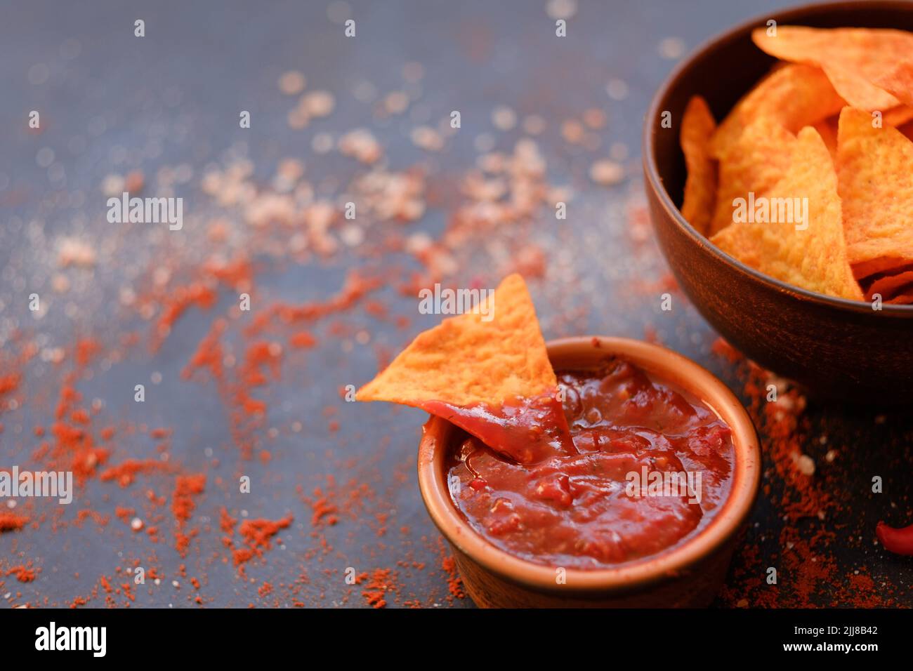 junk fast food eating nacho chips tomato sauce dip Stock Photo - Alamy