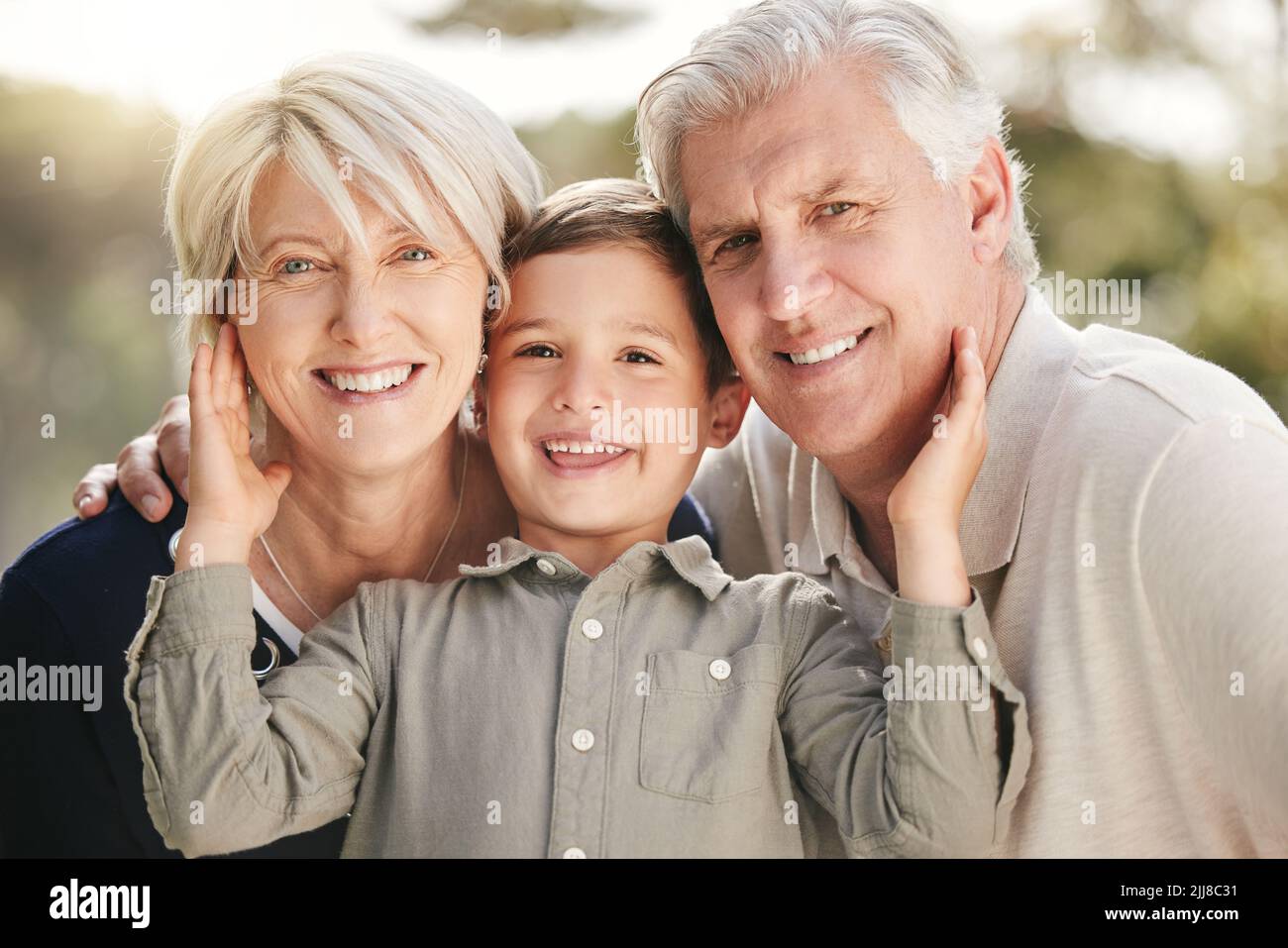 Portrait of loving caucasian grandparents enjoying time with grandson ...