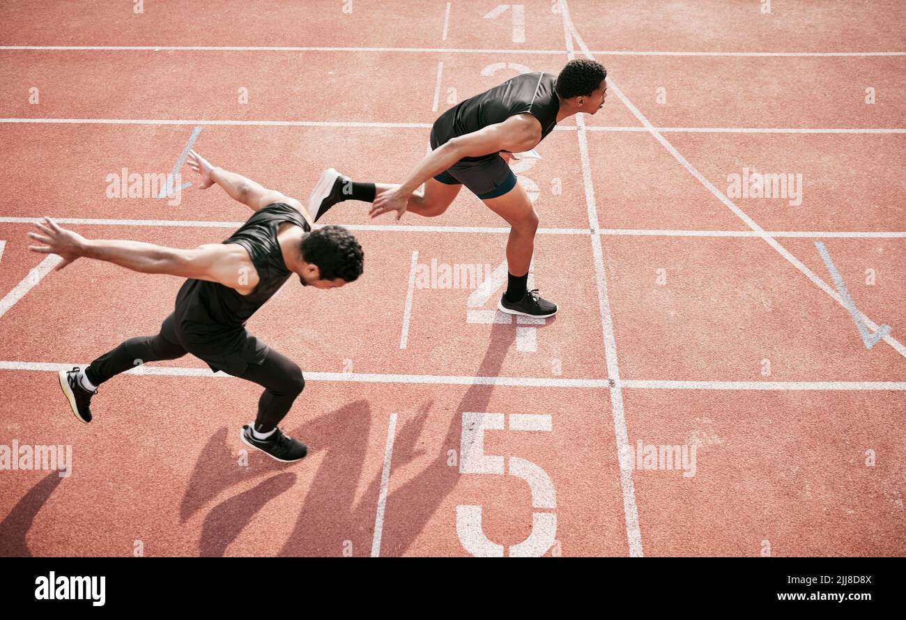 Ahead by an inch. High angle shot of two handsome young male athletes ...