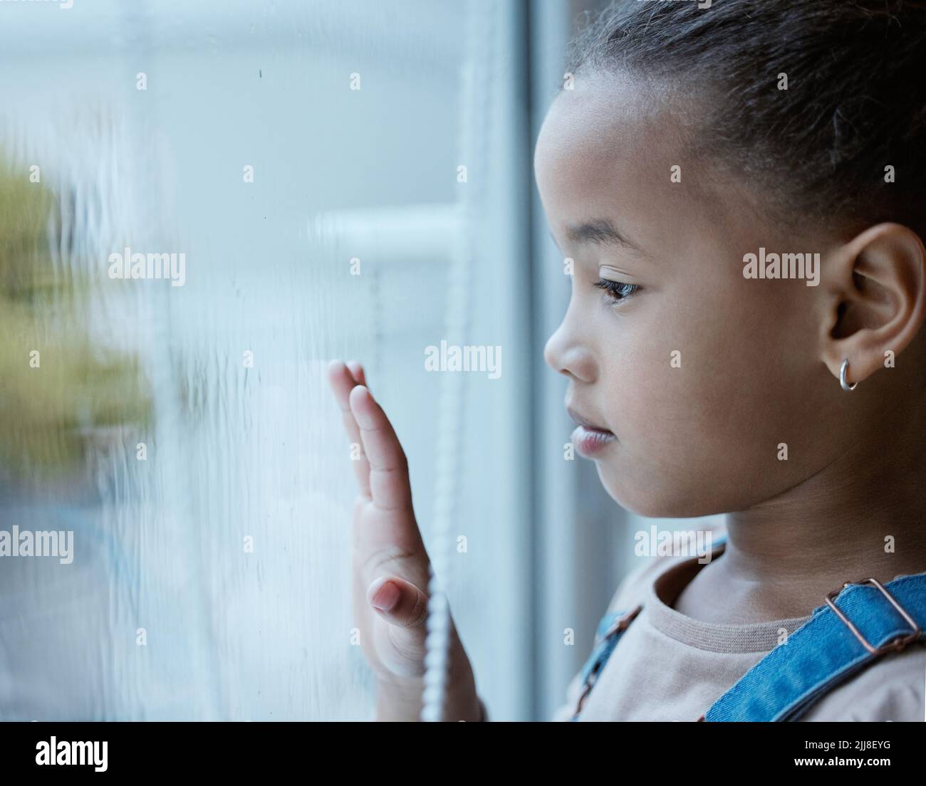 Girl looking out window sad rain hi-res stock photography and images ...
