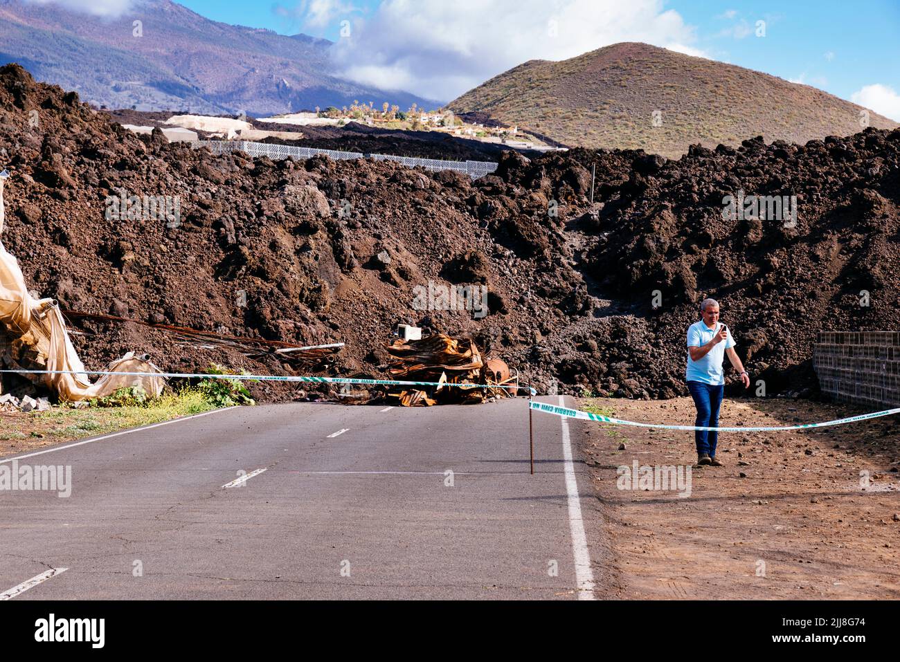 Closed road by the solidified lava river. Destruction caused by the ...