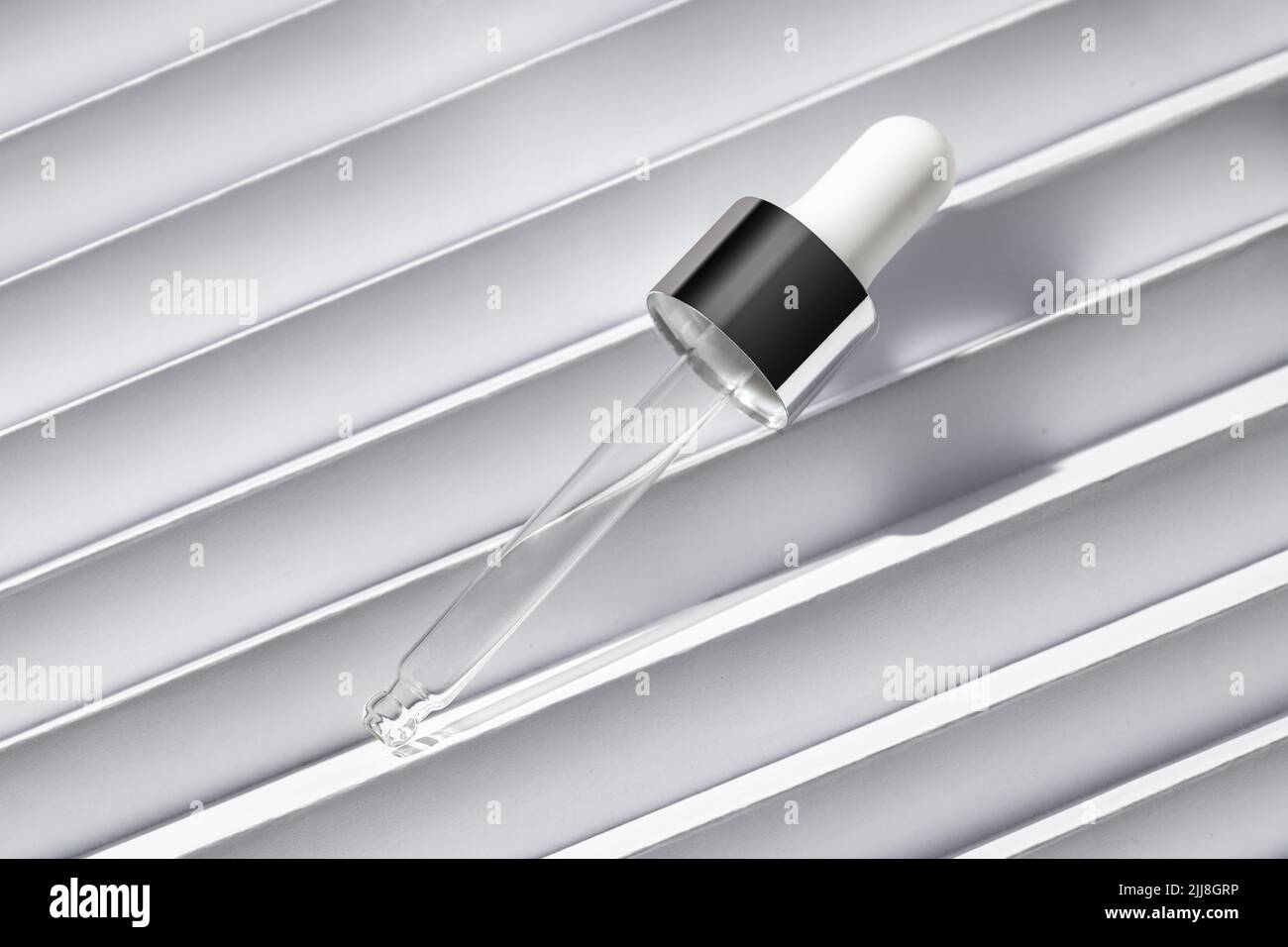 Luxury empty dropper on white and shaded cascading background Stock ...