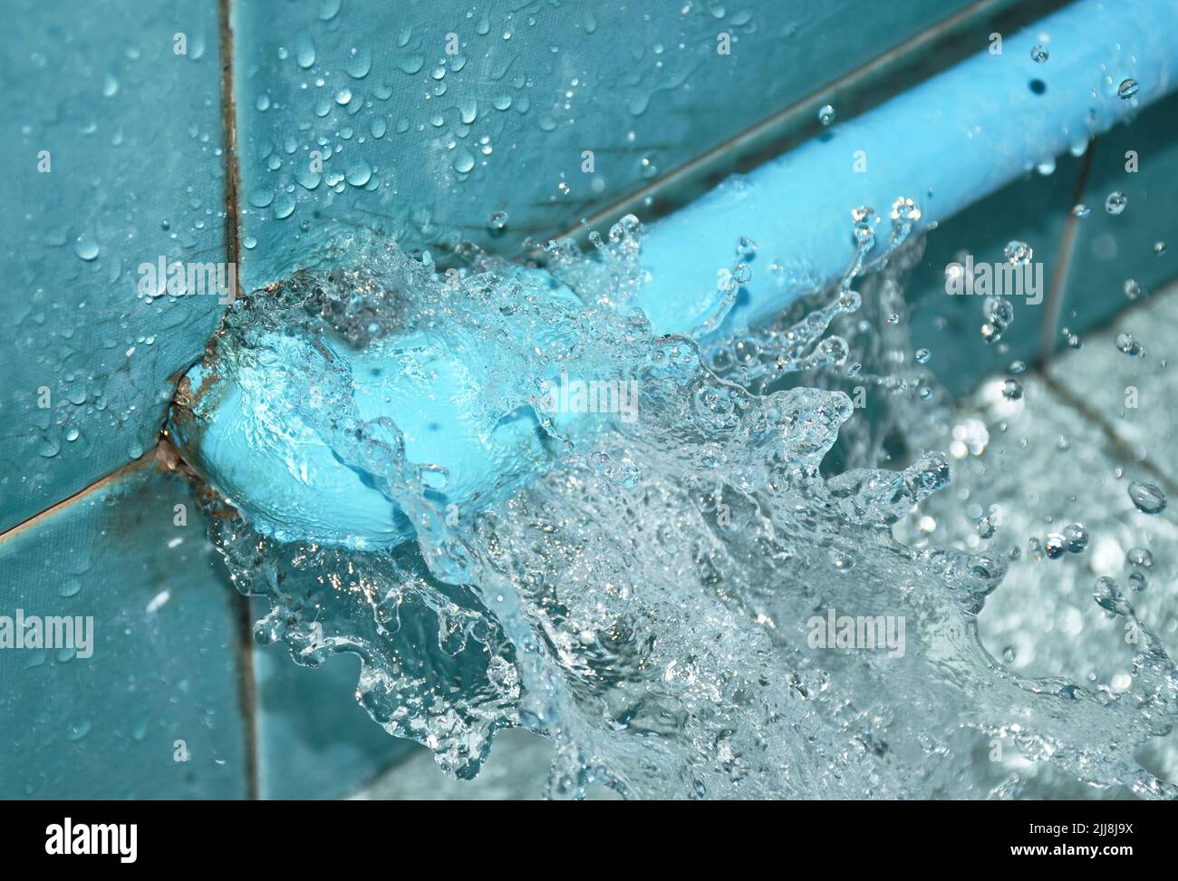 water splashing from broken plumbing blue polythene pipe line in ...