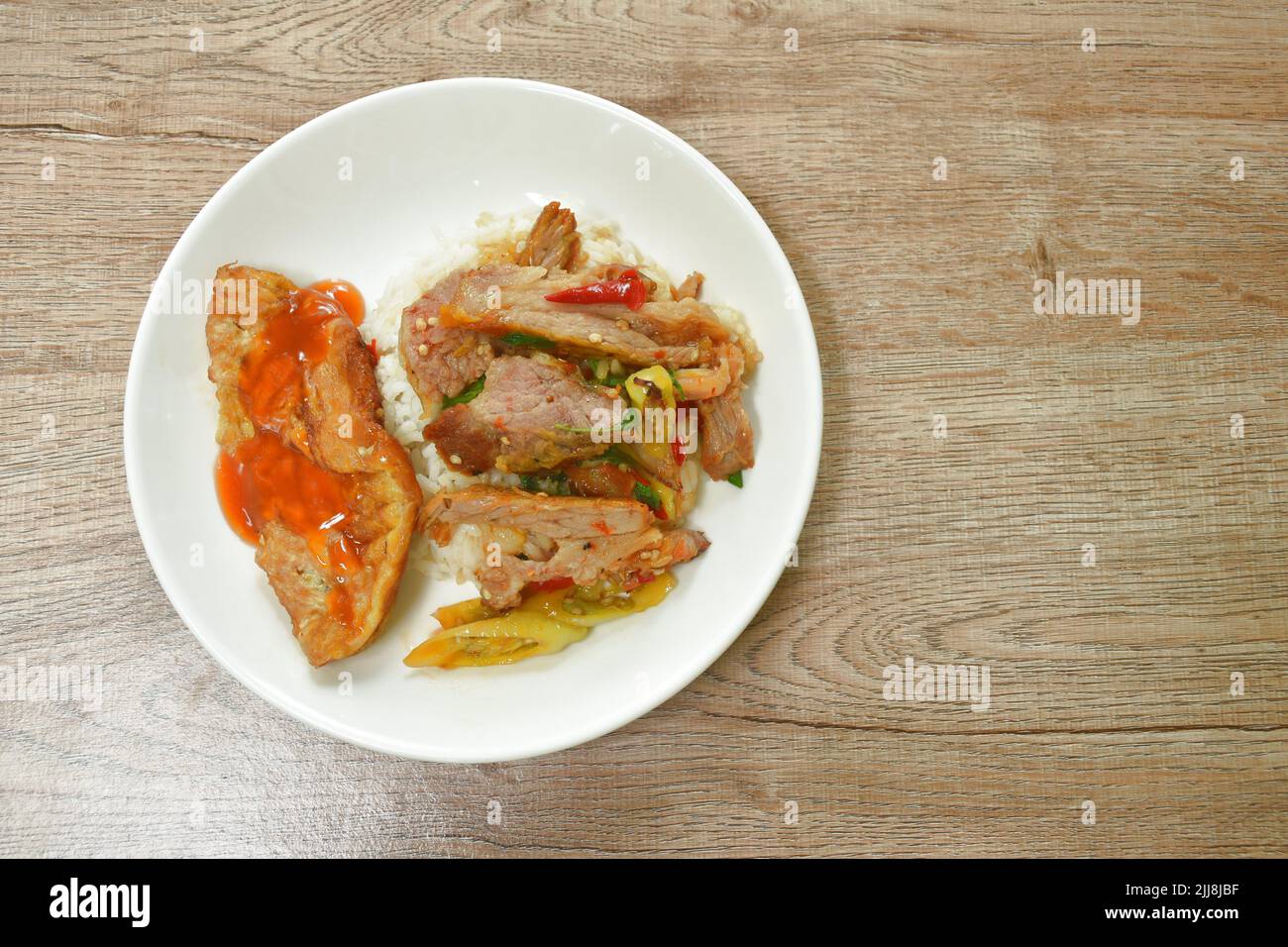 spicy stir fried barbecue pork neck with chili and basil leaf topping ...