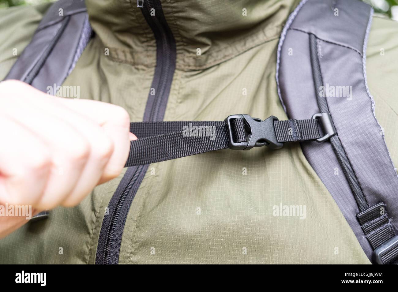 Tighten the chest strap of the backpack. Tighten the belt over your ...