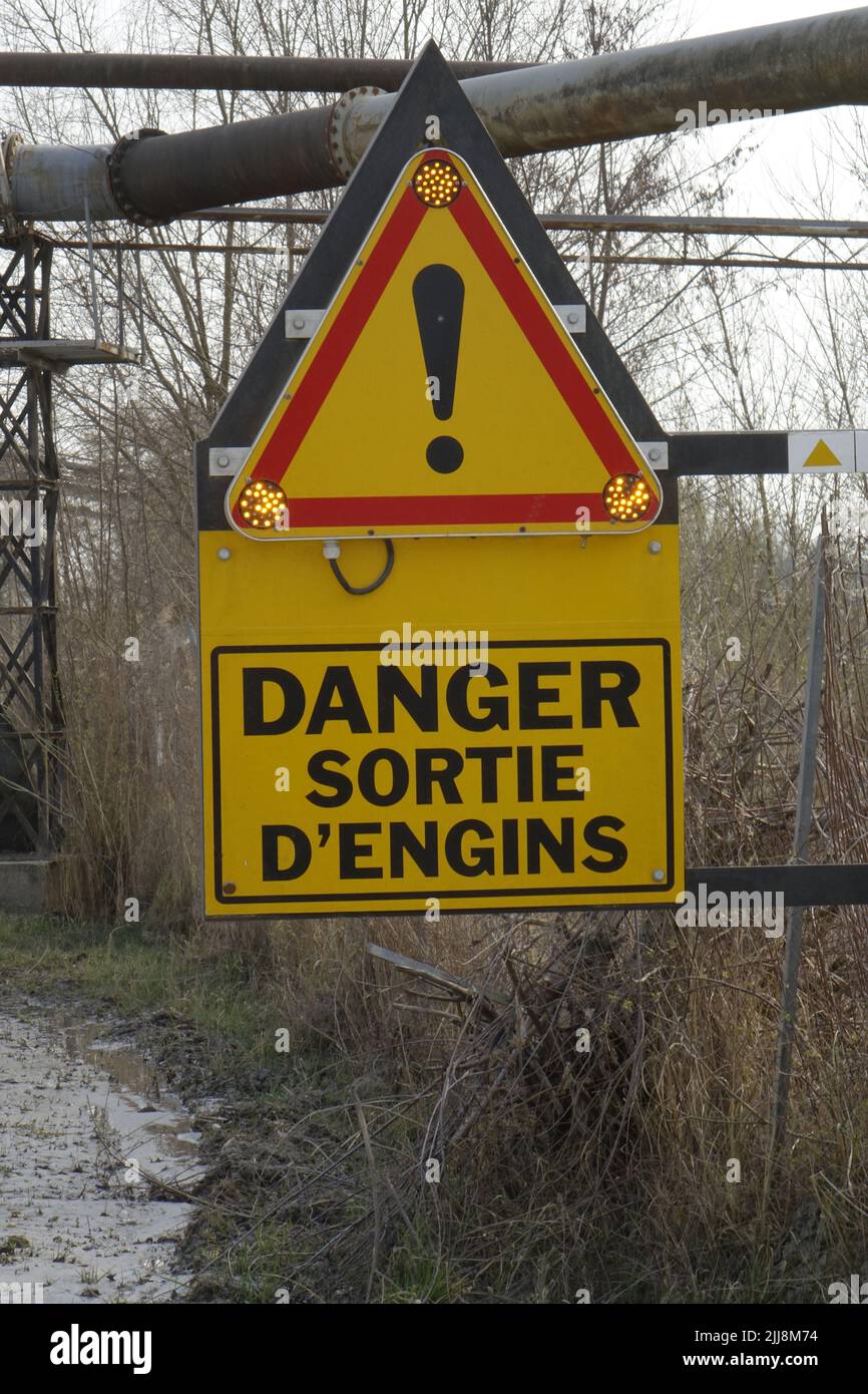 Yellow and red French traffic warning sign 'Danger! Exit of heavy ...