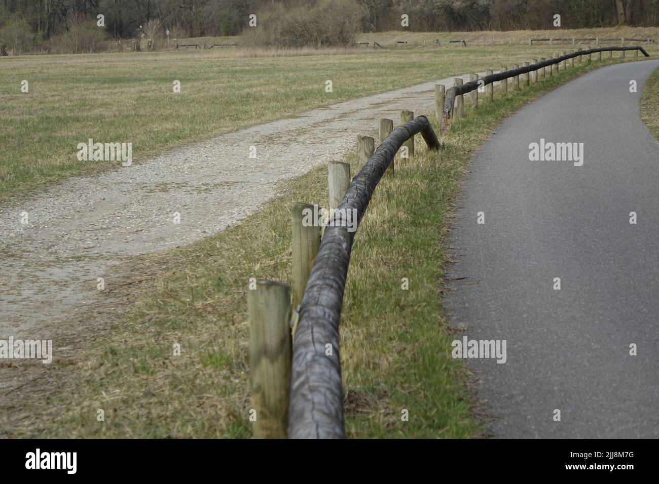 Tarmac bike and hike path and wooden guardrail in Sauer Delta National ...