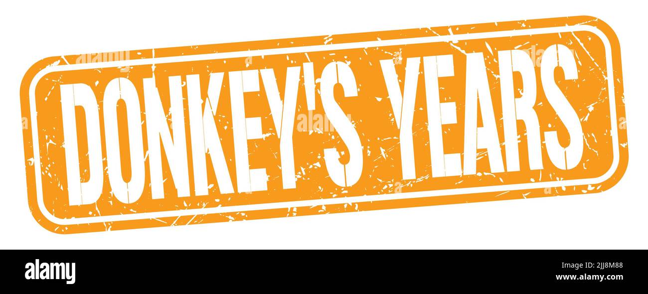 DONKEY'S YEARS text written on orange grungy stamp sign Stock Photo - Alamy