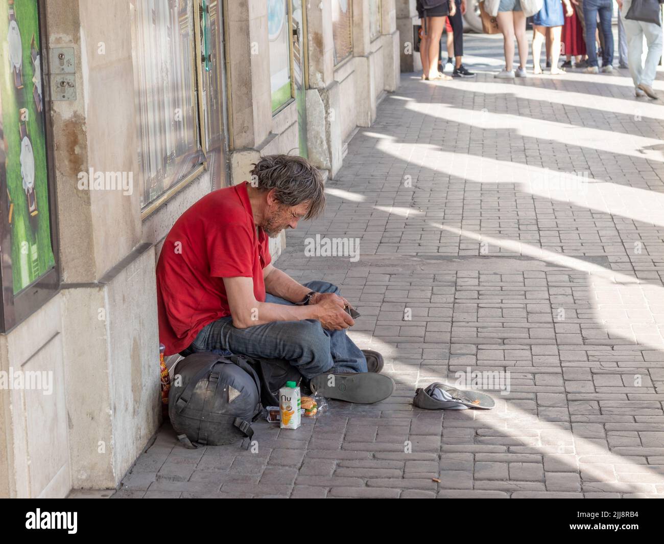 PARIS / FRANCE - JUNE 28, 2019: homeless man sitting on the sidewalk in ...