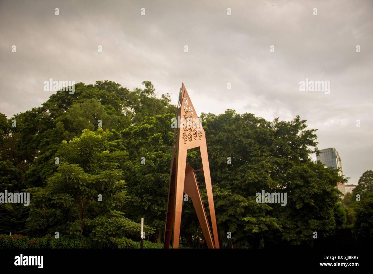 The view of a wooden statue with the laser cut design placed outdoors ...