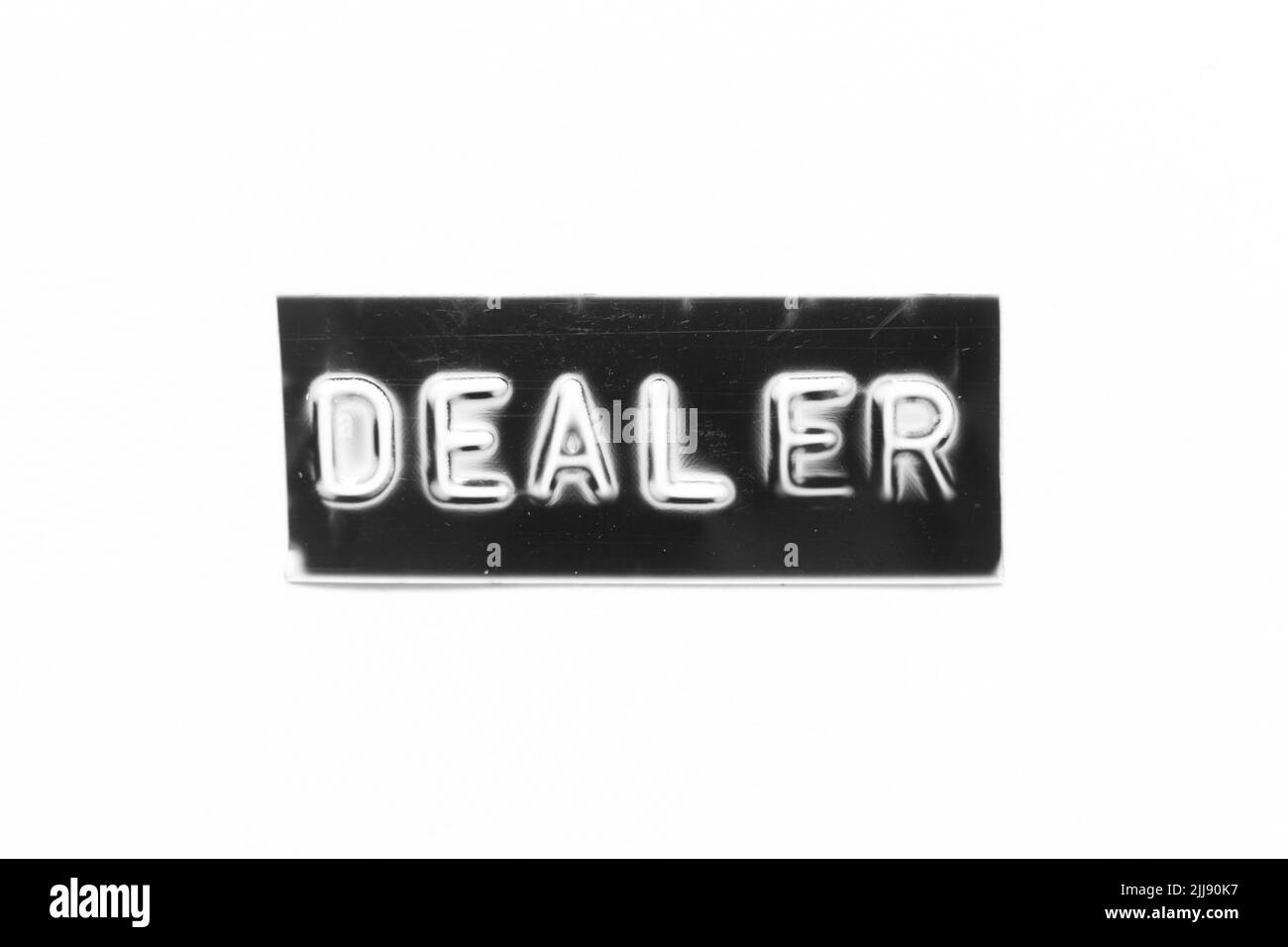 Black color banner that have embossed letter with word dealer on white ...