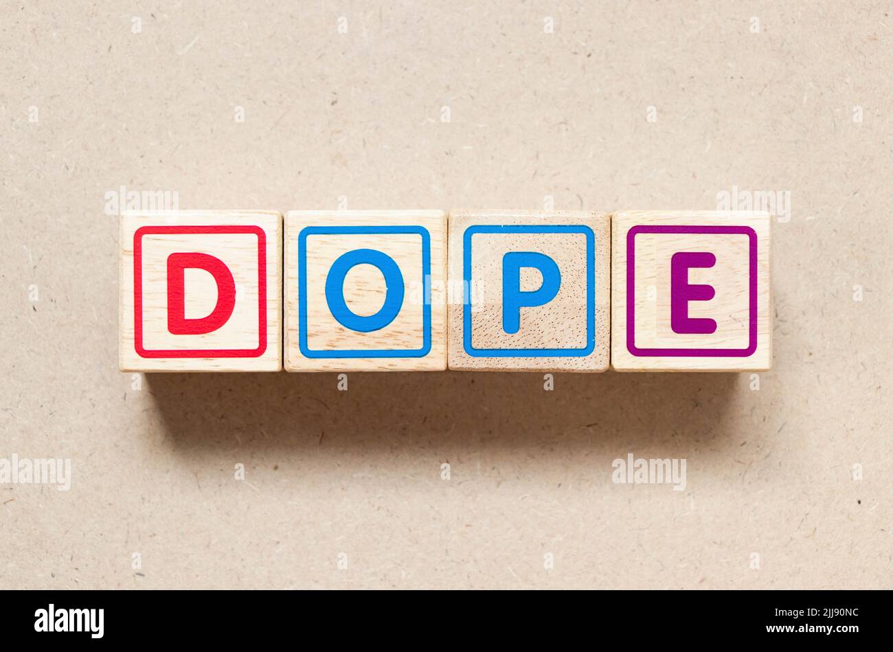 Color letter block in word dope on wood background Stock Photo - Alamy