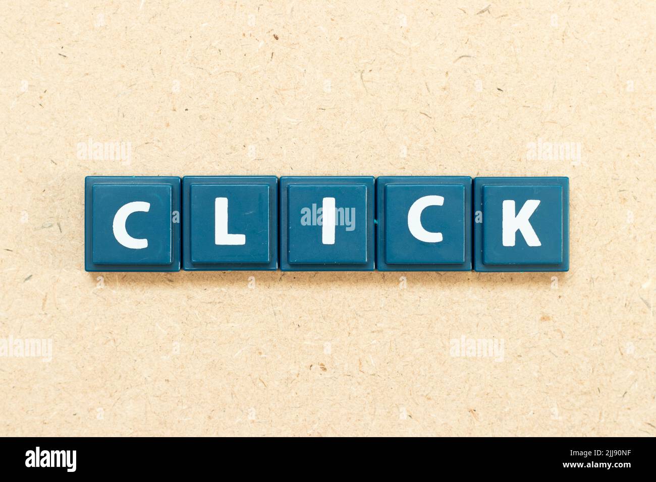 Tile alphabet letter in word click on wood background Stock Photo - Alamy