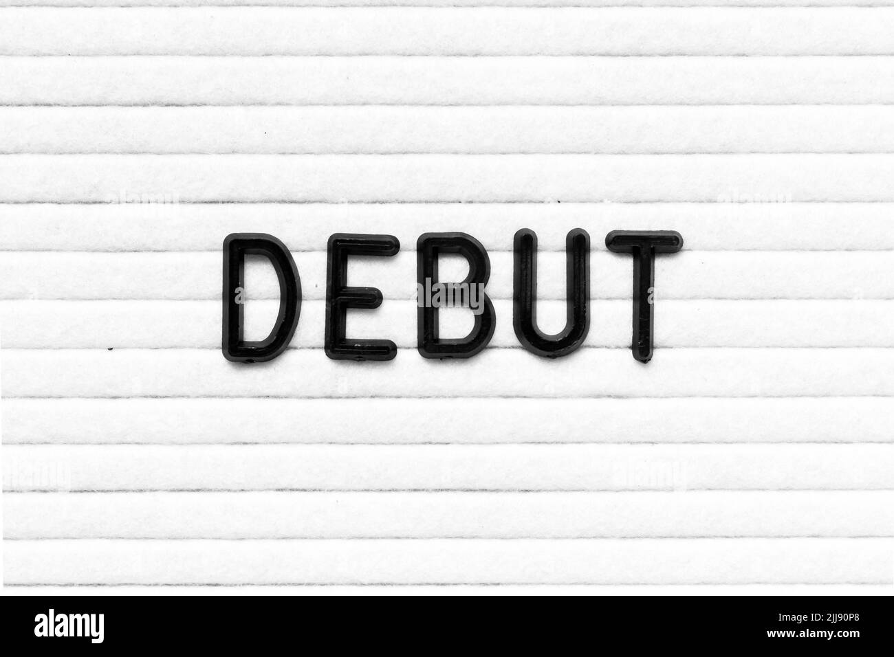 Black color letter in word debut on white felt board background Stock ...