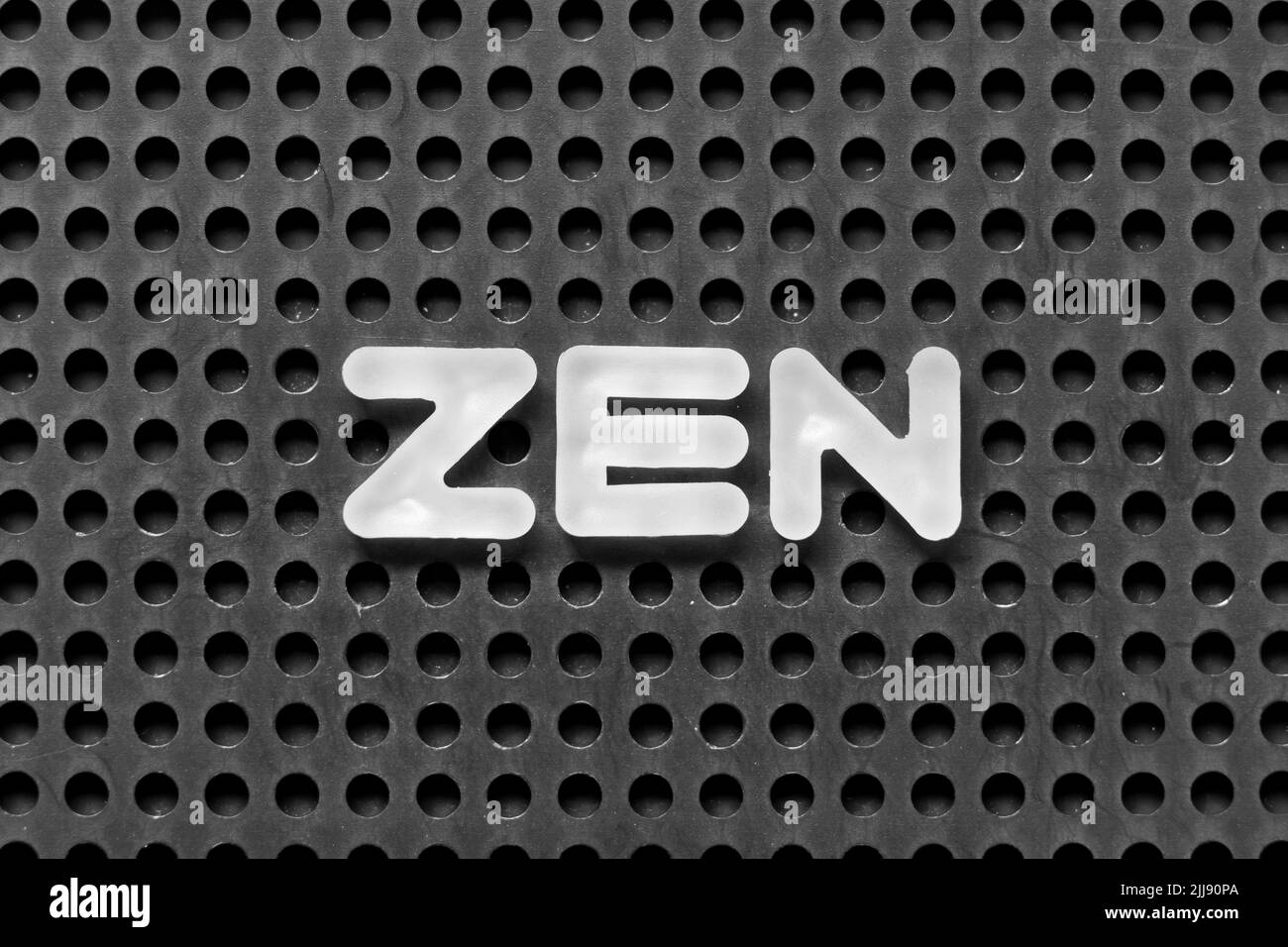 White alphabet letter in word zen on black pegboard background Stock ...