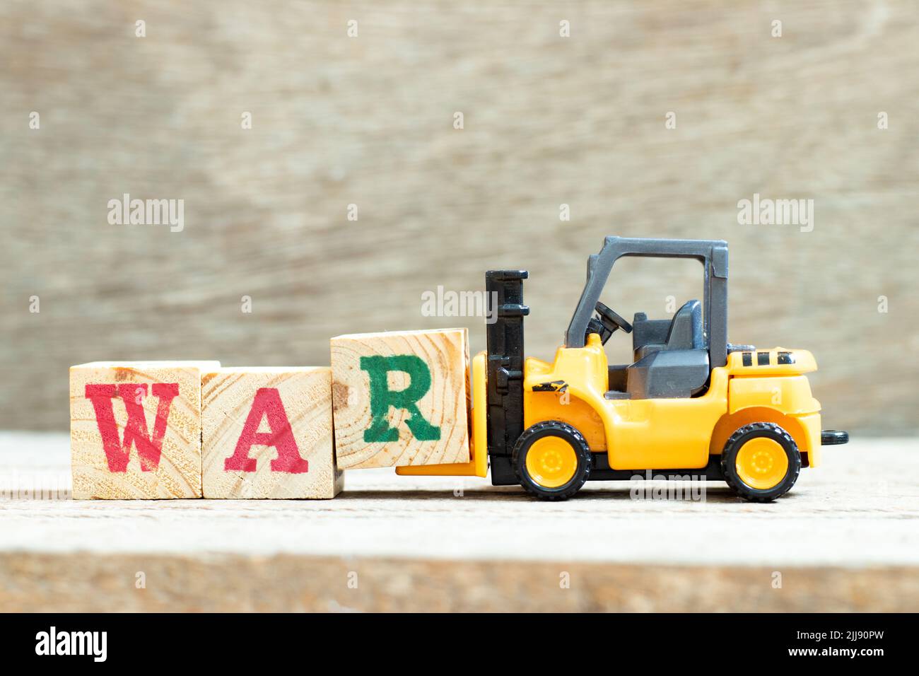 Toy forklift hold letter block R to complete word war on wood ... Toy forklift hold letter block R to complete word war on wood ...