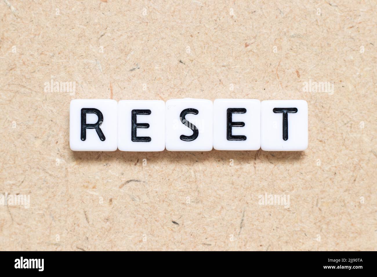 White tile alphabet letter with word reset on wood background Stock ...