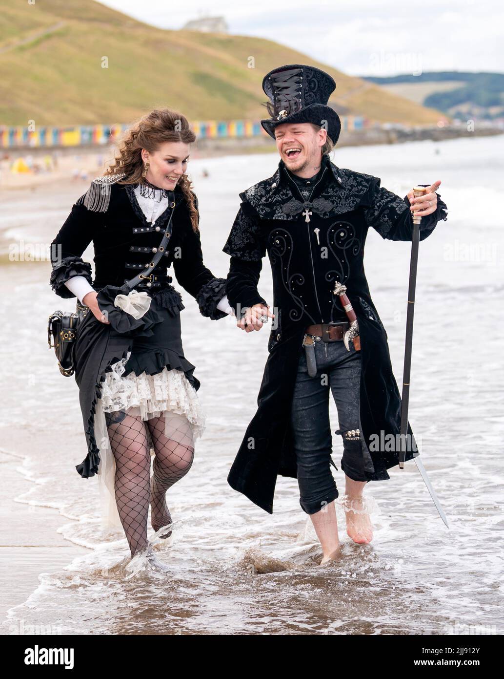 Emma Parfett and Shaun Smith paddle in the sea during the Whitby ...