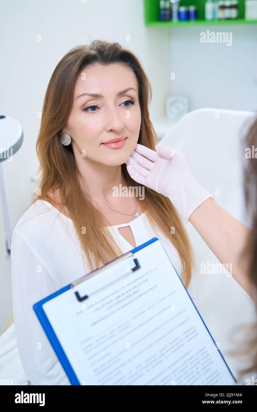 Doctor touches patient face with gloved hand Stock Photo - Alamy