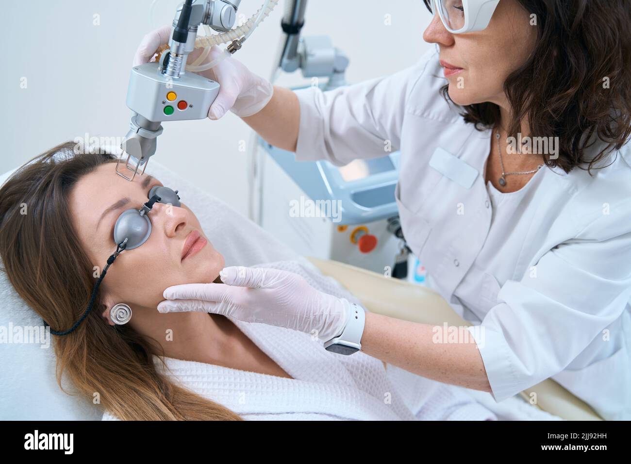 Woman undergoes a procedure for laser removal of neoplasms in the ...