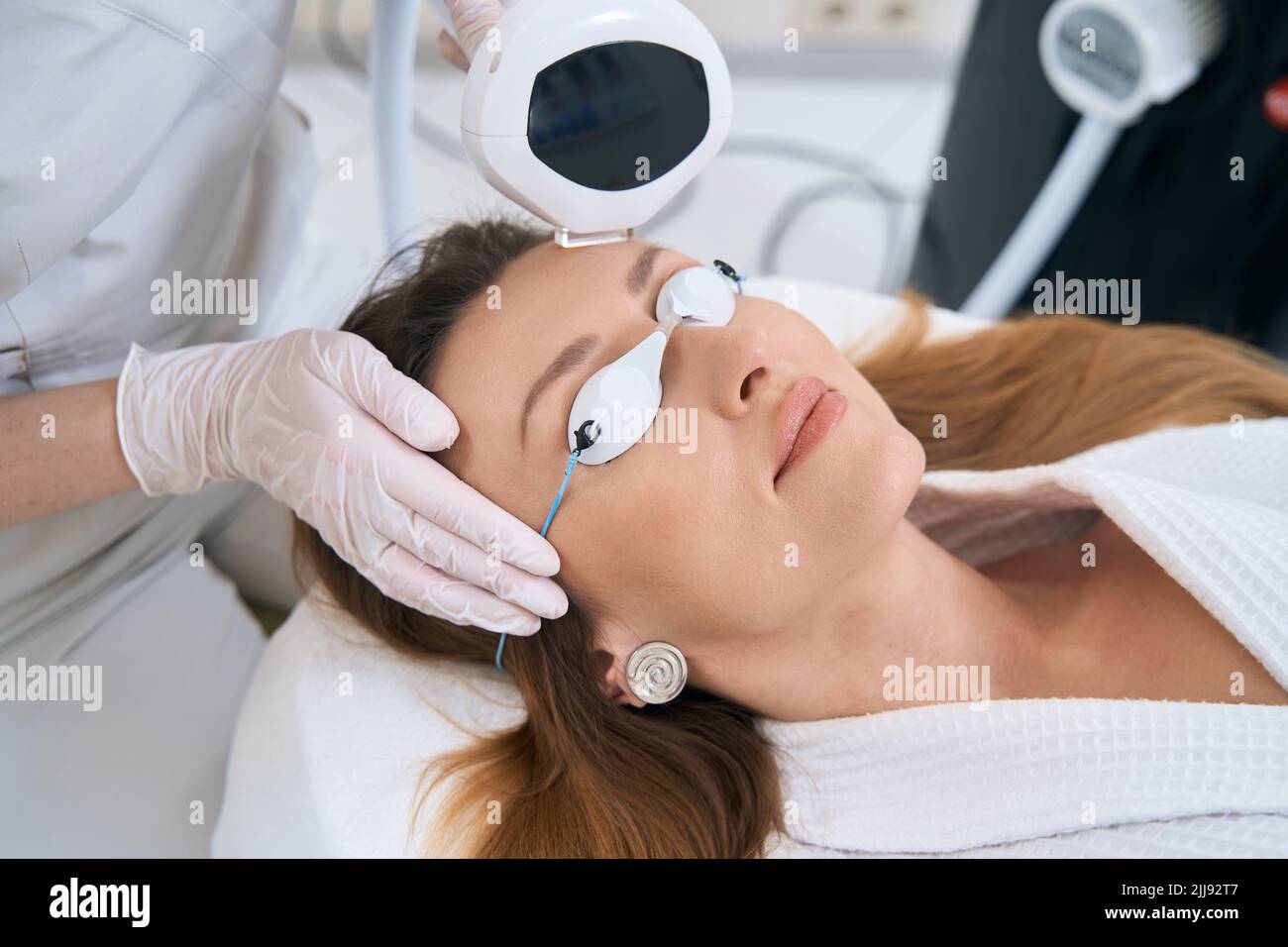 Patient in cosmetology center undergoes a forehead skin rejuvenation ...