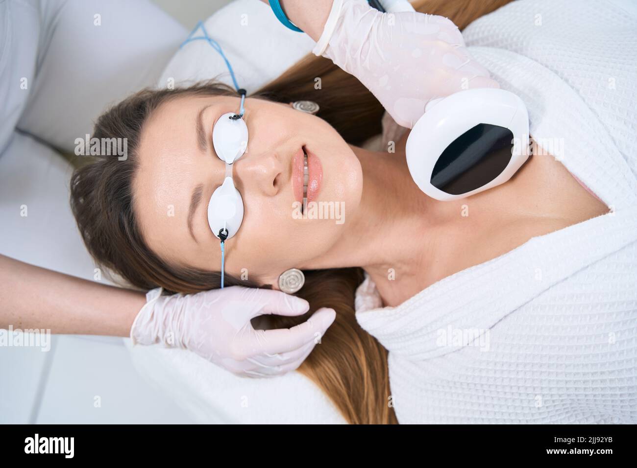 Female patient during procedure for rejuvenating the skin of the ...