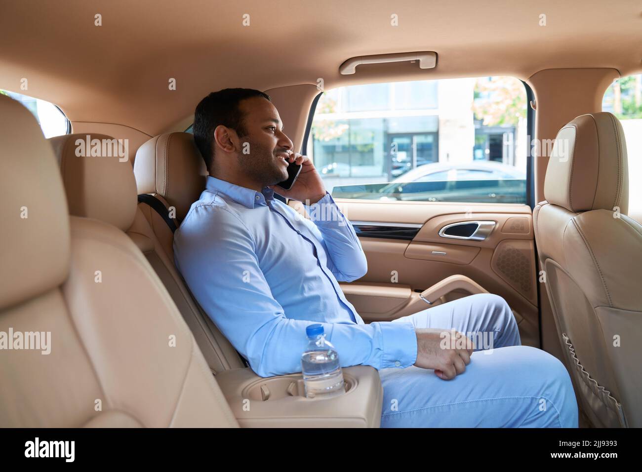 Passenger having conversation on cellphone in car Stock Photo - Alamy