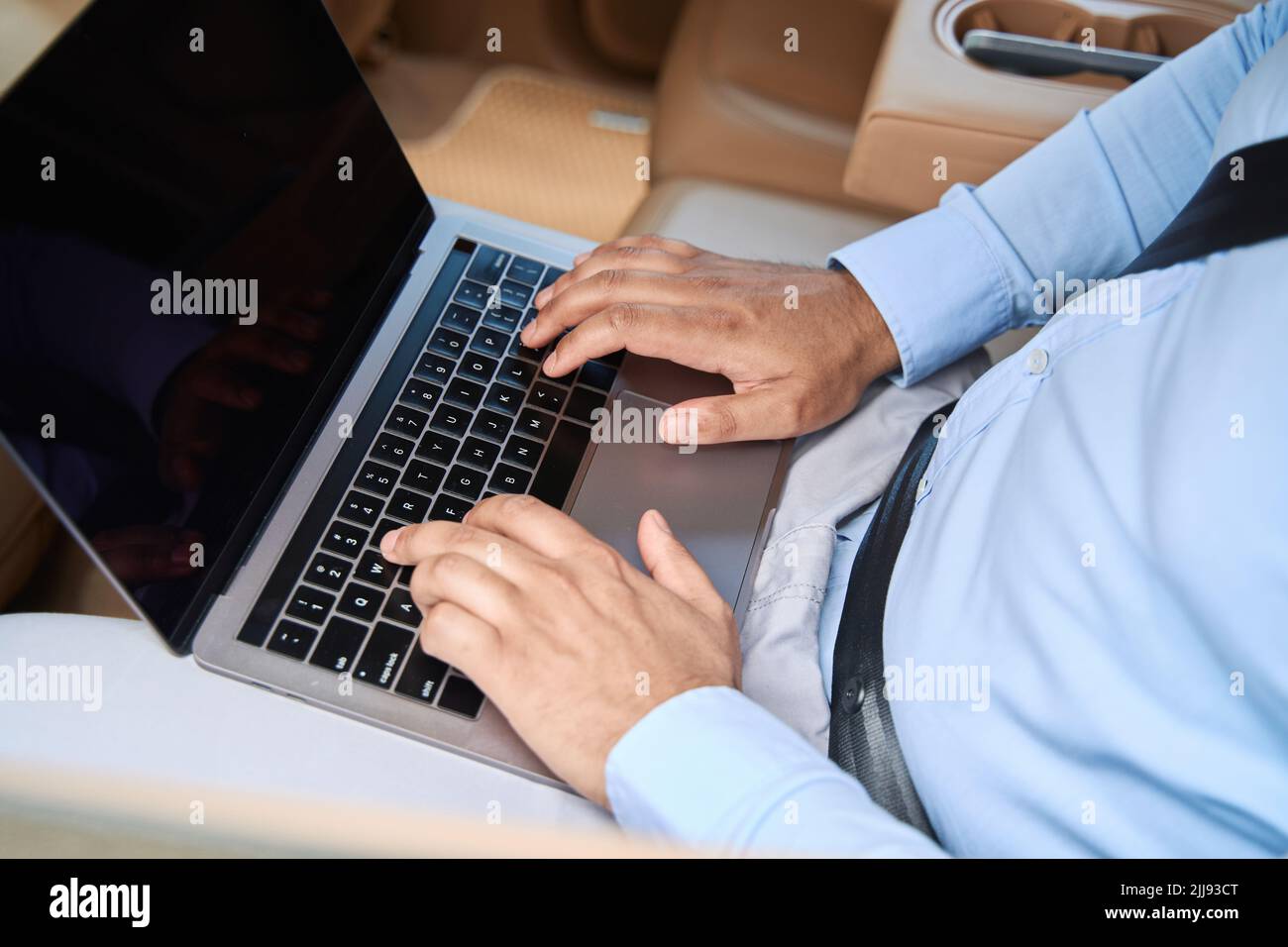 Businessperson working on portable computer in car Stock Photo - Alamy