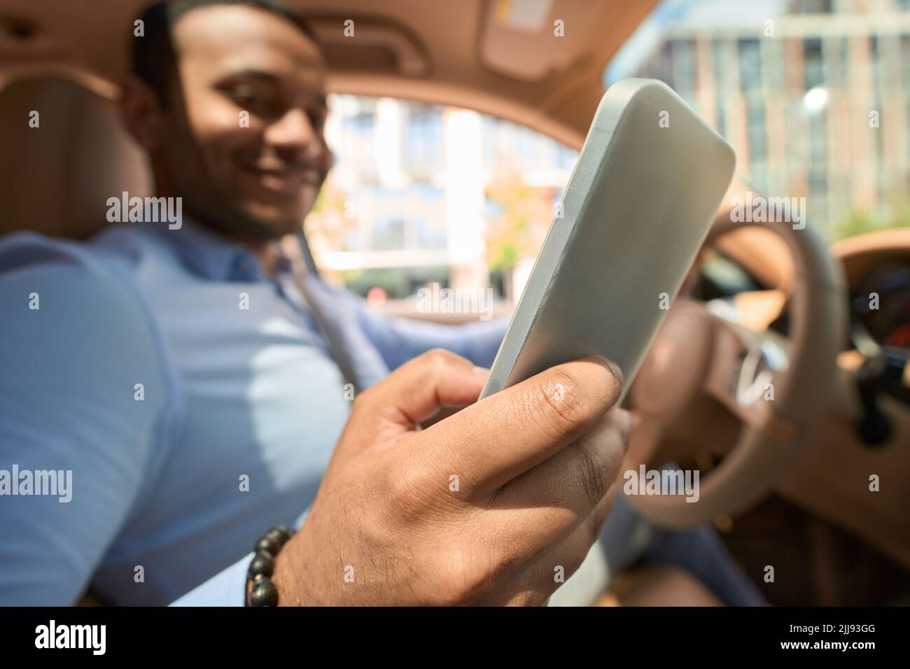 Driver using his cellphone during car trip Stock Photo - Alamy
