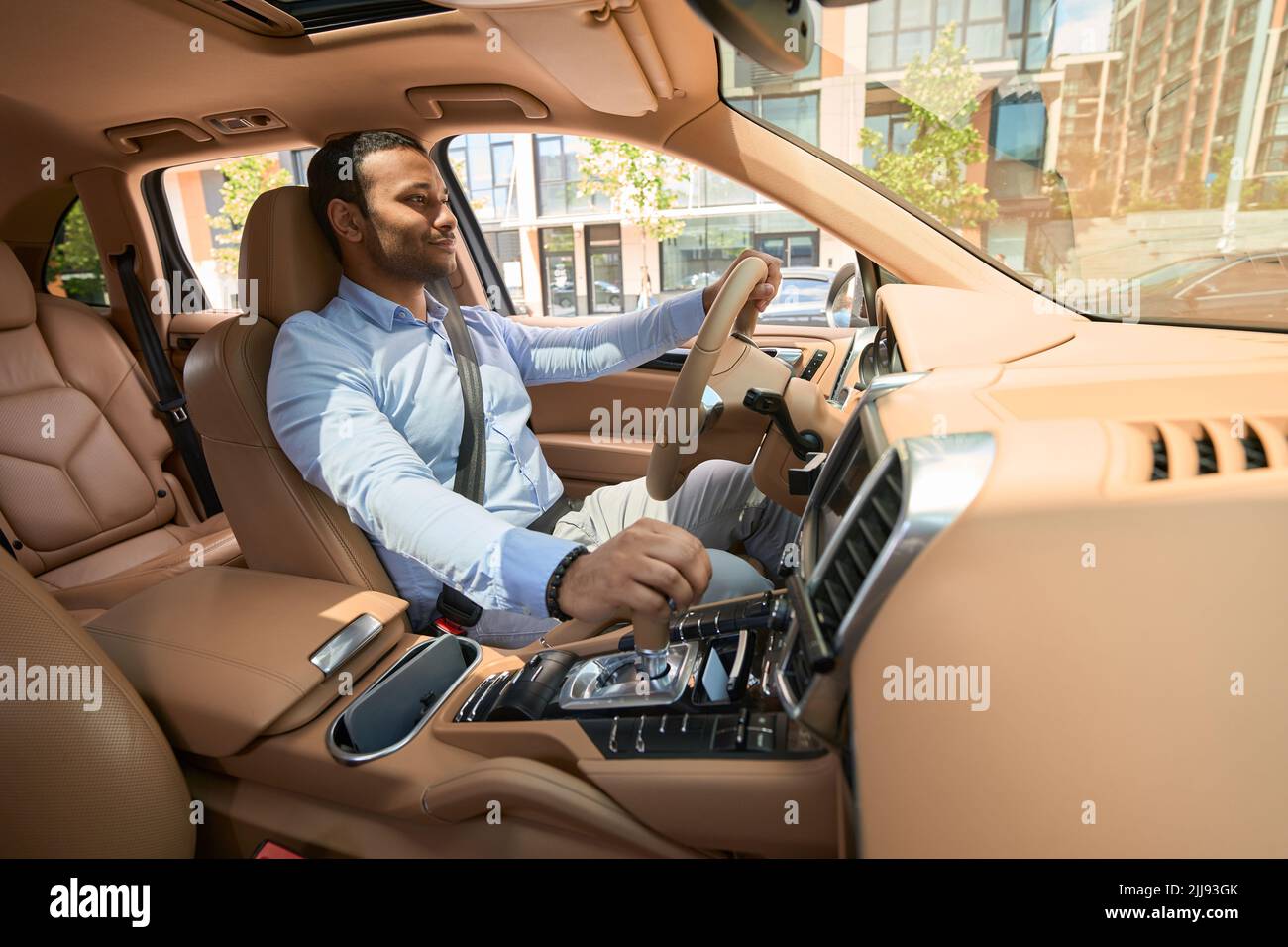 Focused male driver steering his motor vehicle Stock Photo - Alamy