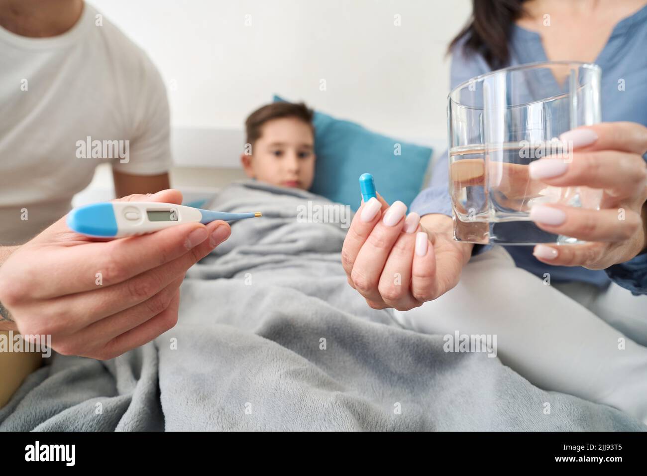 Caring parents take care of their son during illness Stock Photo - Alamy