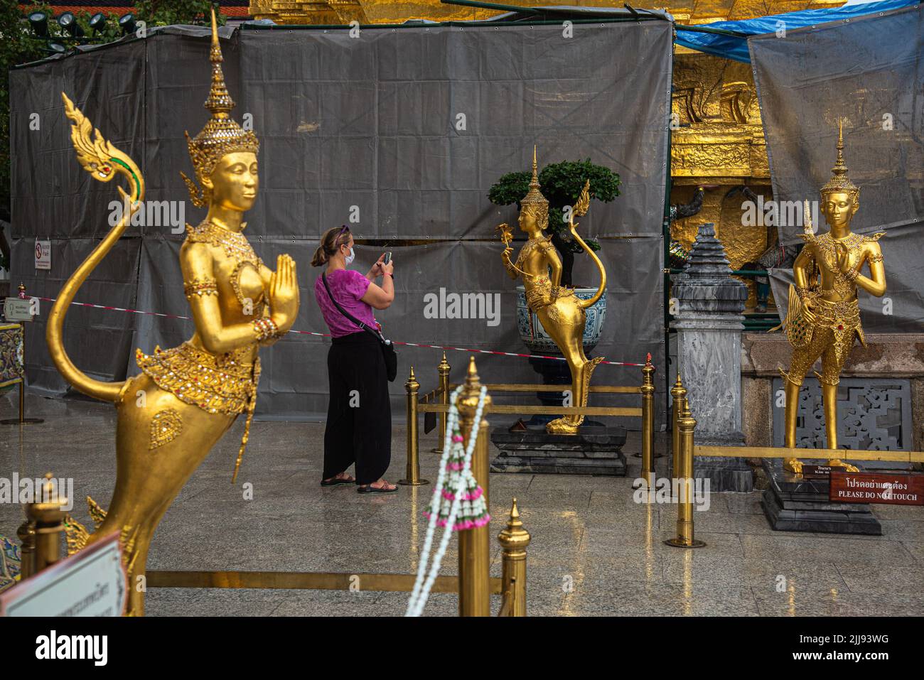 A tourist takes photos while visiting Wat Phra Kaew in Bangkok. (Photo by Peerapon Boonyakiat ...