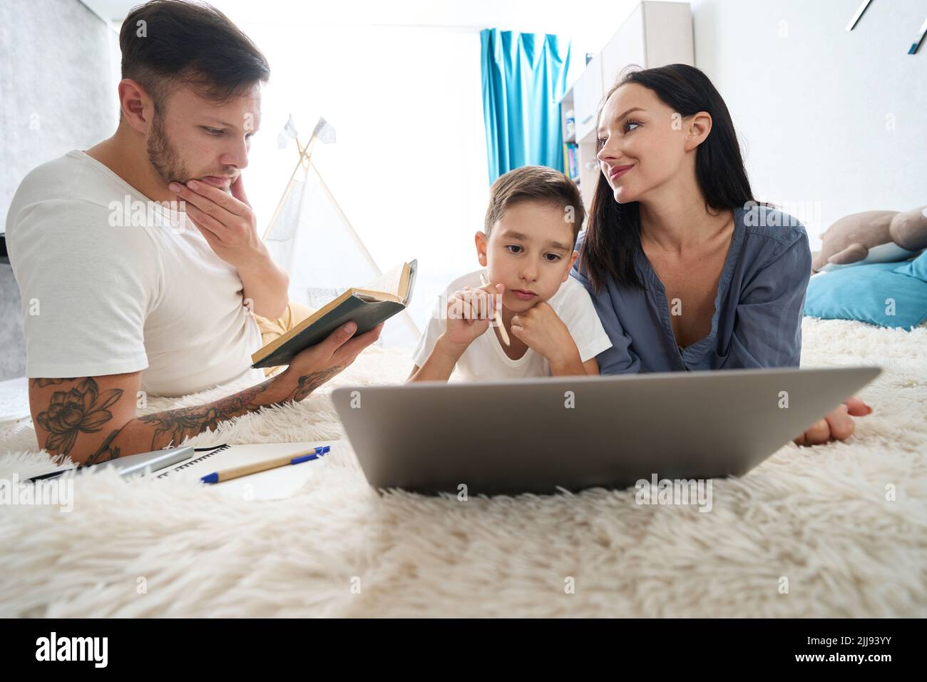 Family coping with son difficult homework together Stock Photo - Alamy