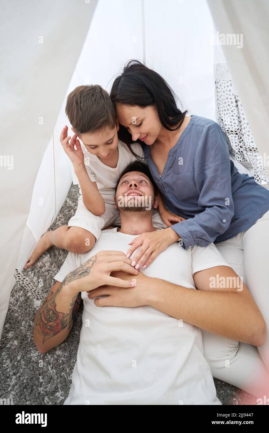 Cheerful family hugs of dad, mom and son in magic hut Stock Photo - Alamy